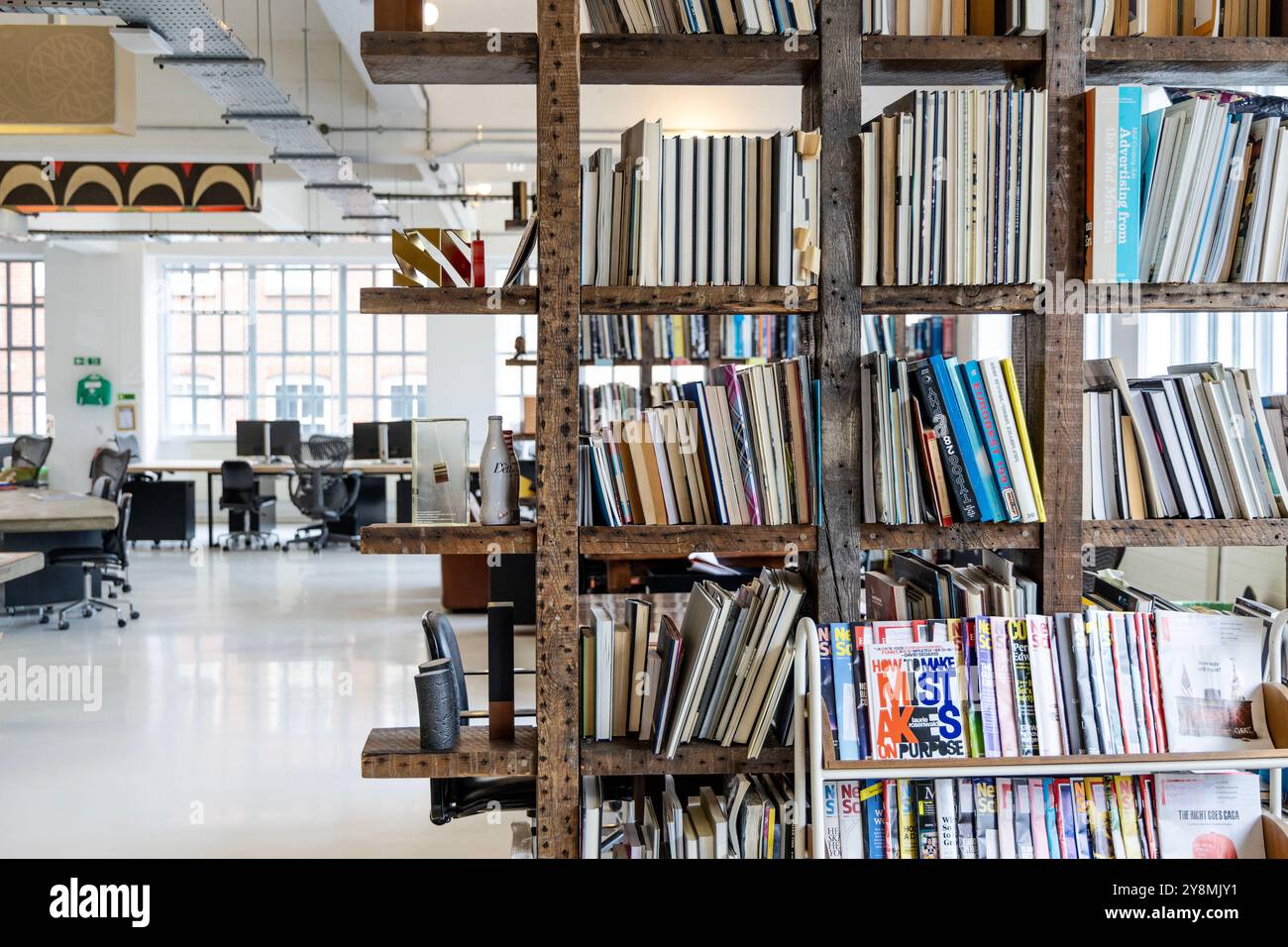 Book shelf made of reclaimed wood at Mother agency office space inside ...