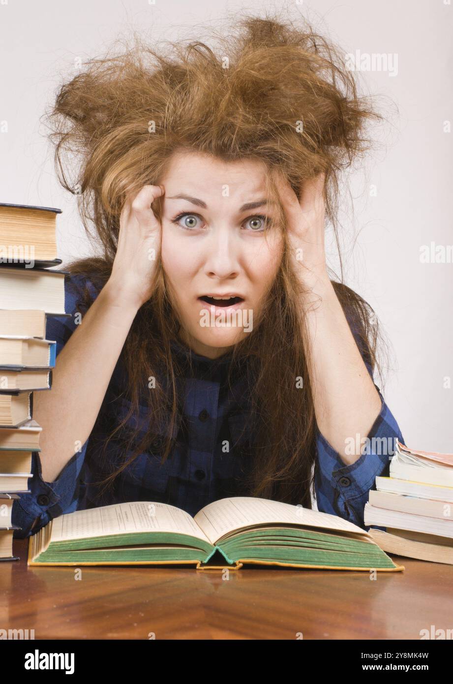 Student girl with books shows panic expression Stock Photo - Alamy