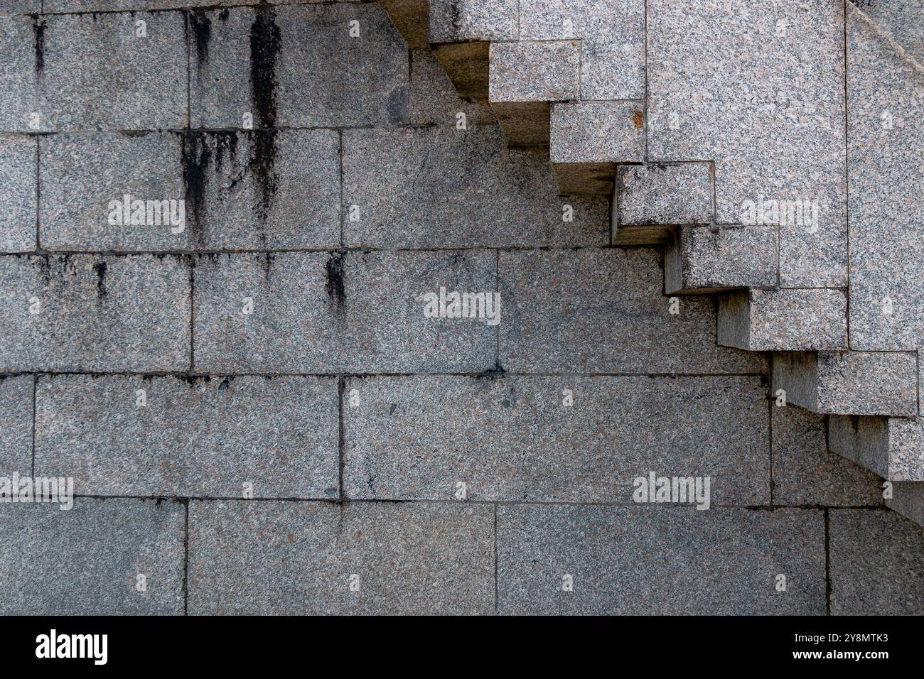 Stone stairs built on a gray granite wall Texture concept Stock Photo ...