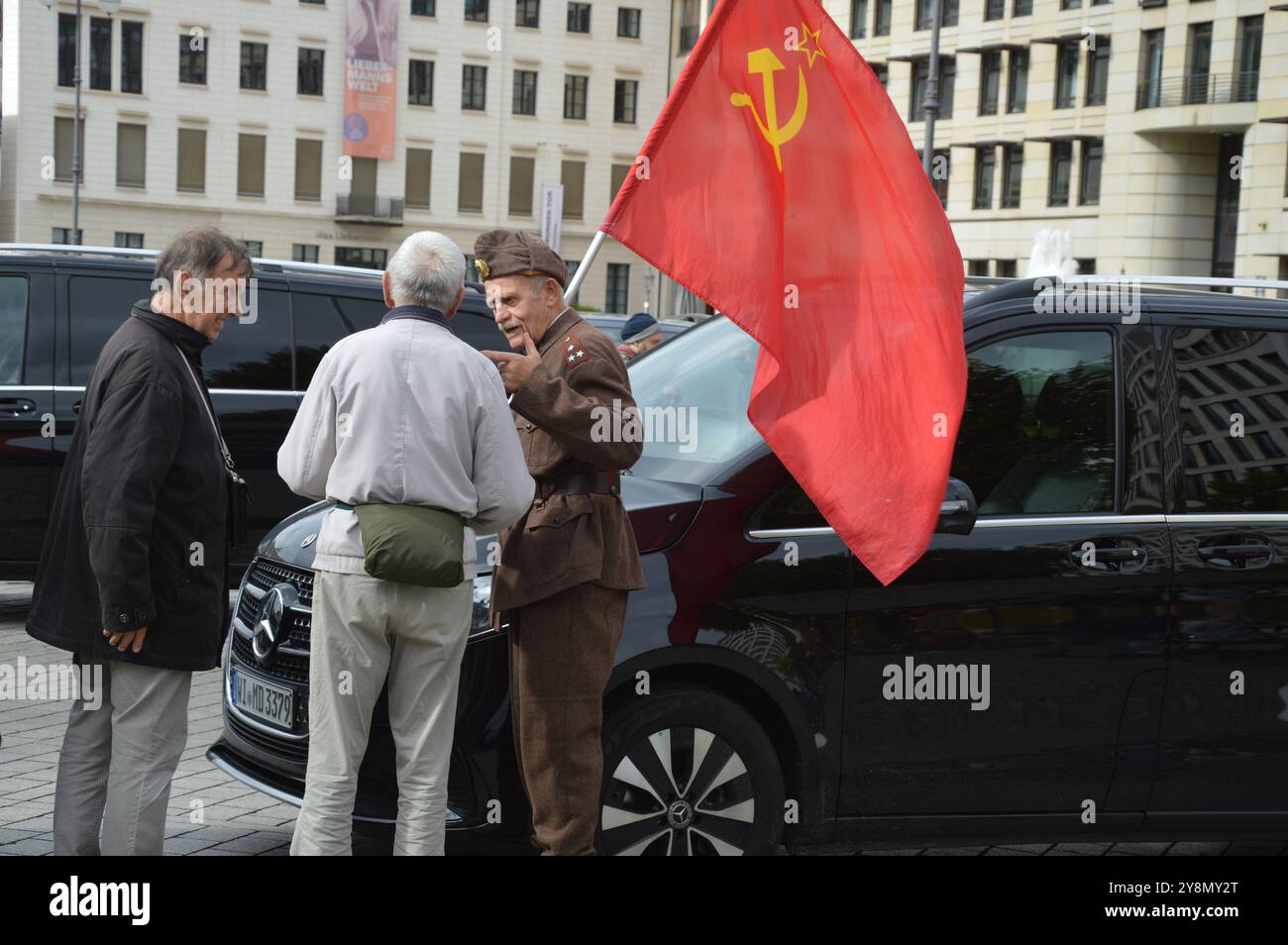 Berlin, Germany - October 3, 2024 - An elderly man with the flag of the ...