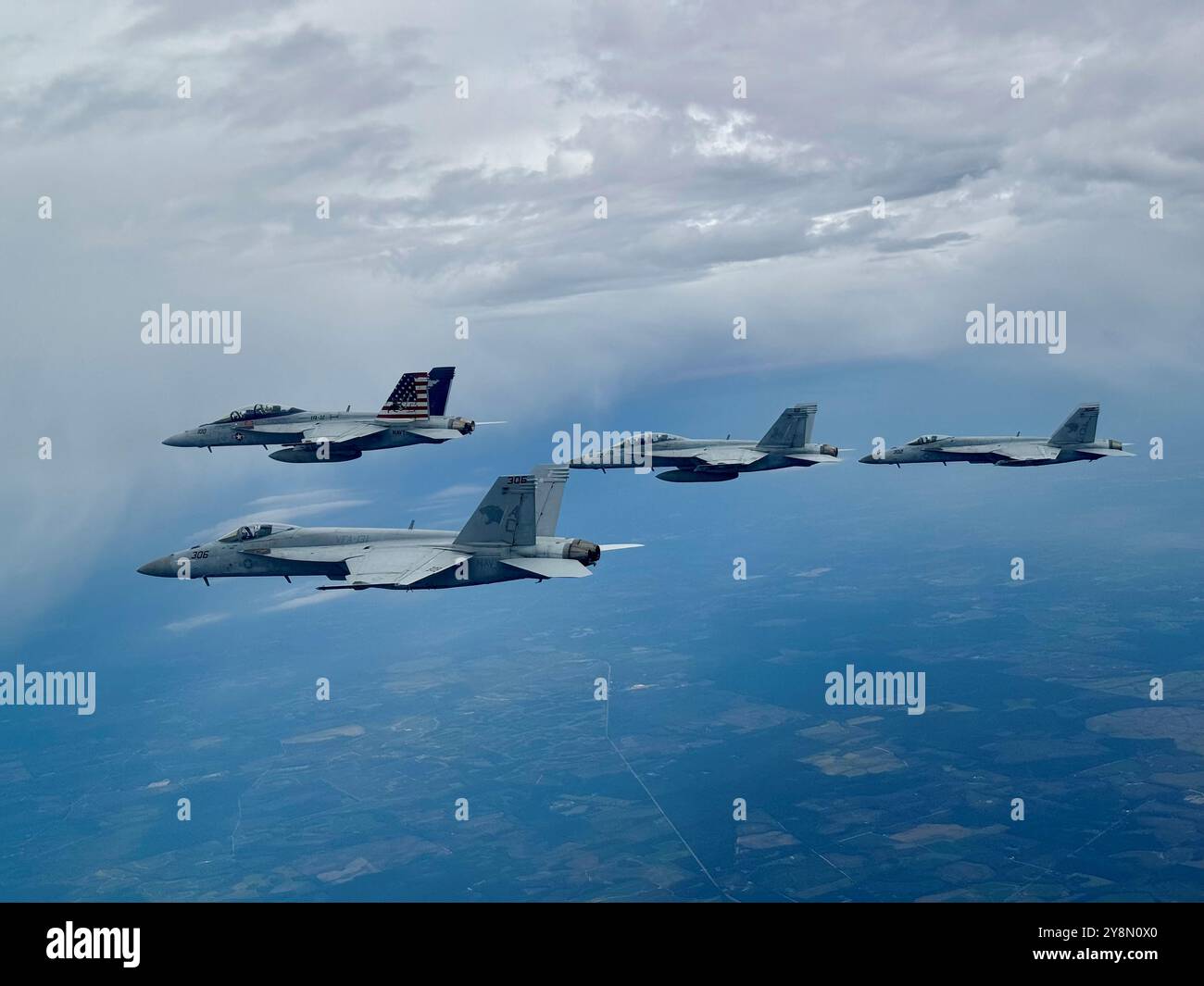 Four U.S. Navy F/A-18E/F Super Hornets conduct a formation flyover to ...