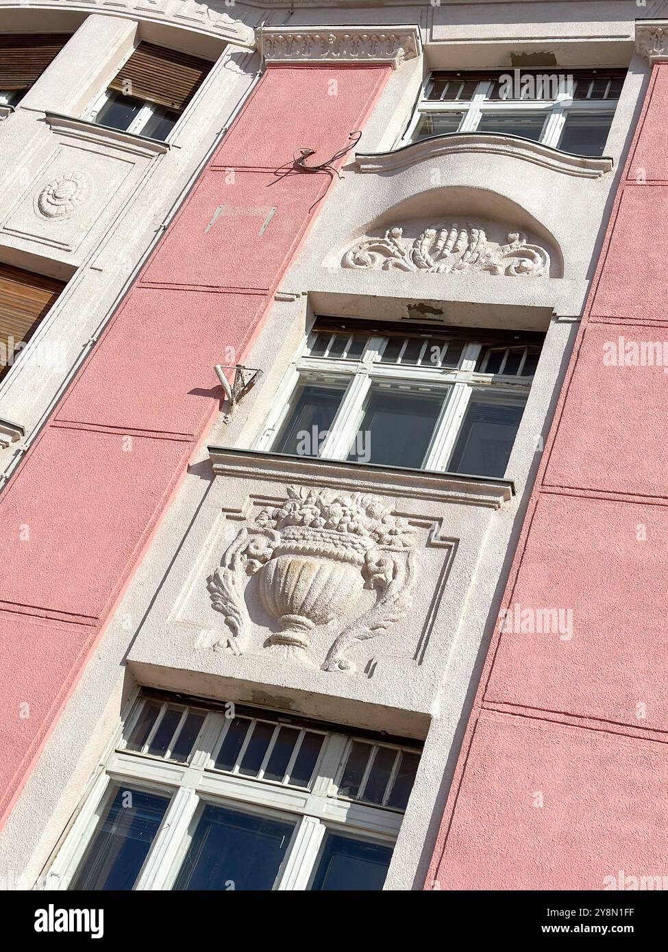 Ornate details of a historic building facade illuminated by sunlight ...