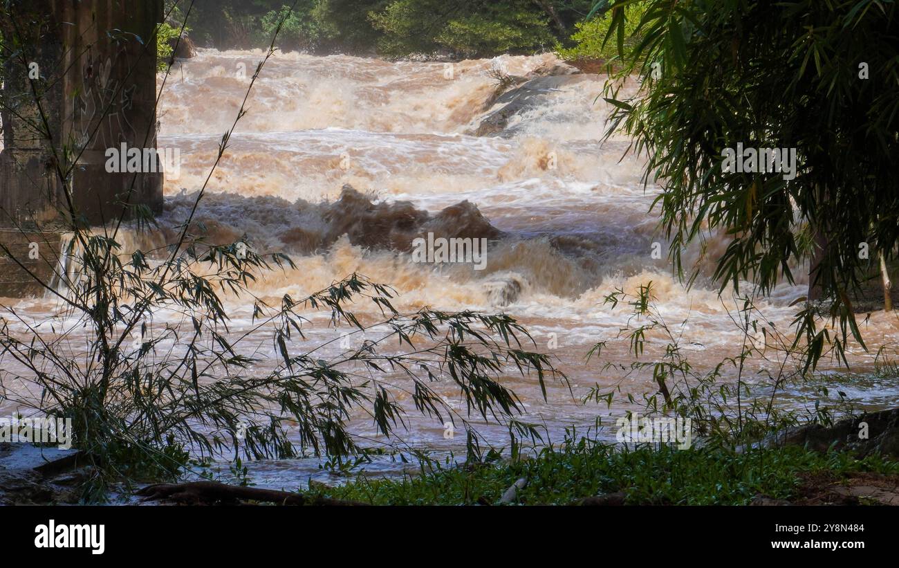 A strong current near a waterfall. Floods flowing in mountain rivers ...