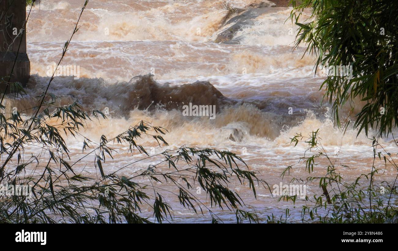 A strong current near a waterfall. Floods flowing in mountain rivers ...