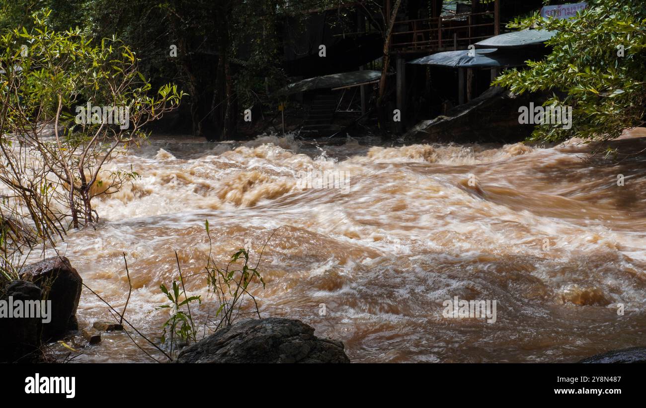 A strong current near a waterfall. Floods flowing in mountain rivers ...