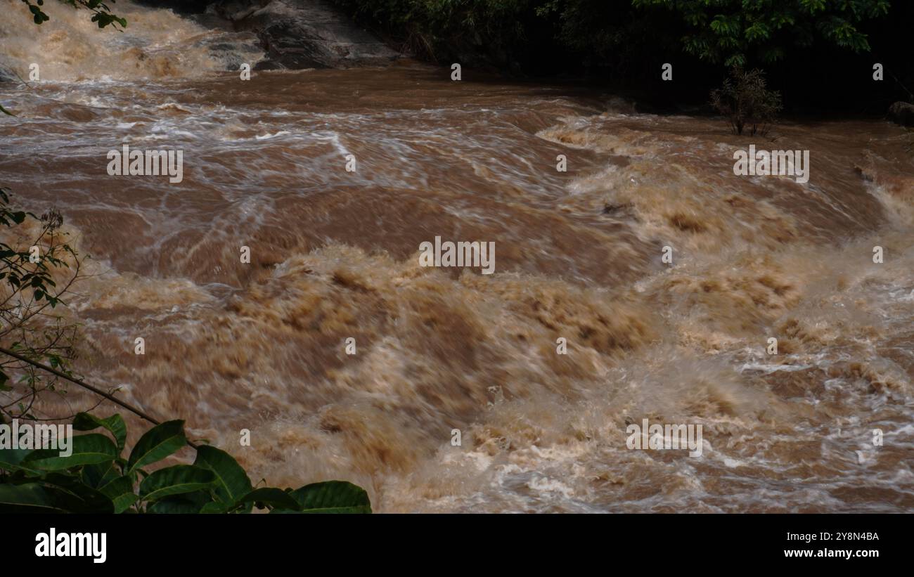 A strong current near a waterfall. Floods flowing in mountain rivers ...