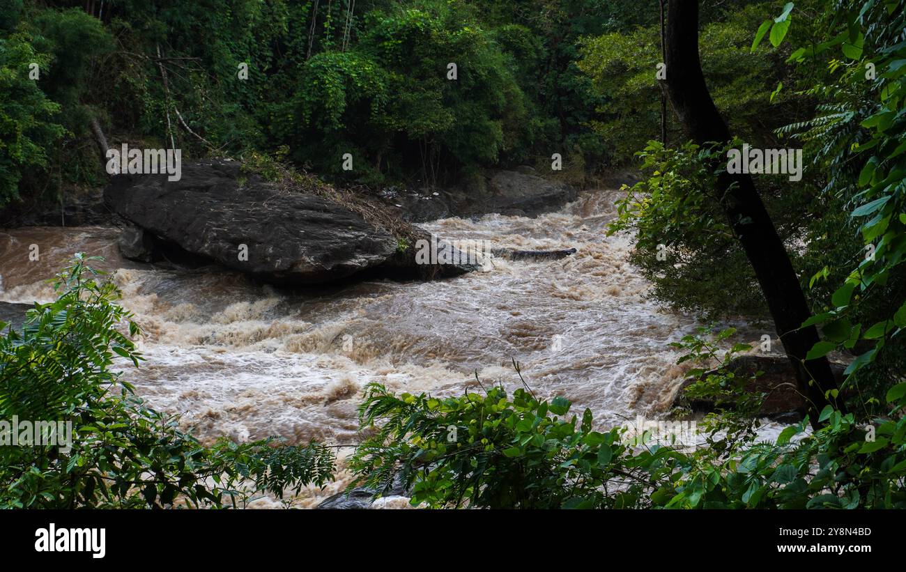 A strong current near a waterfall. Floods flowing in mountain rivers ...