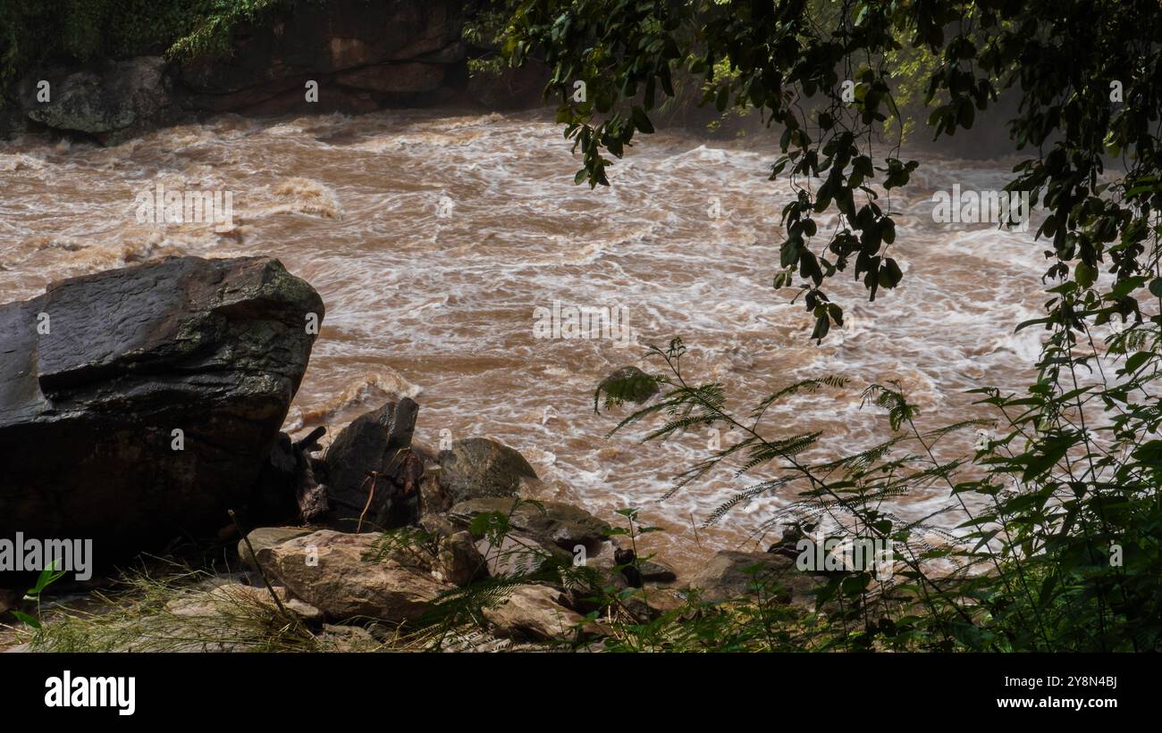 A strong current near a waterfall. Floods flowing in mountain rivers ...