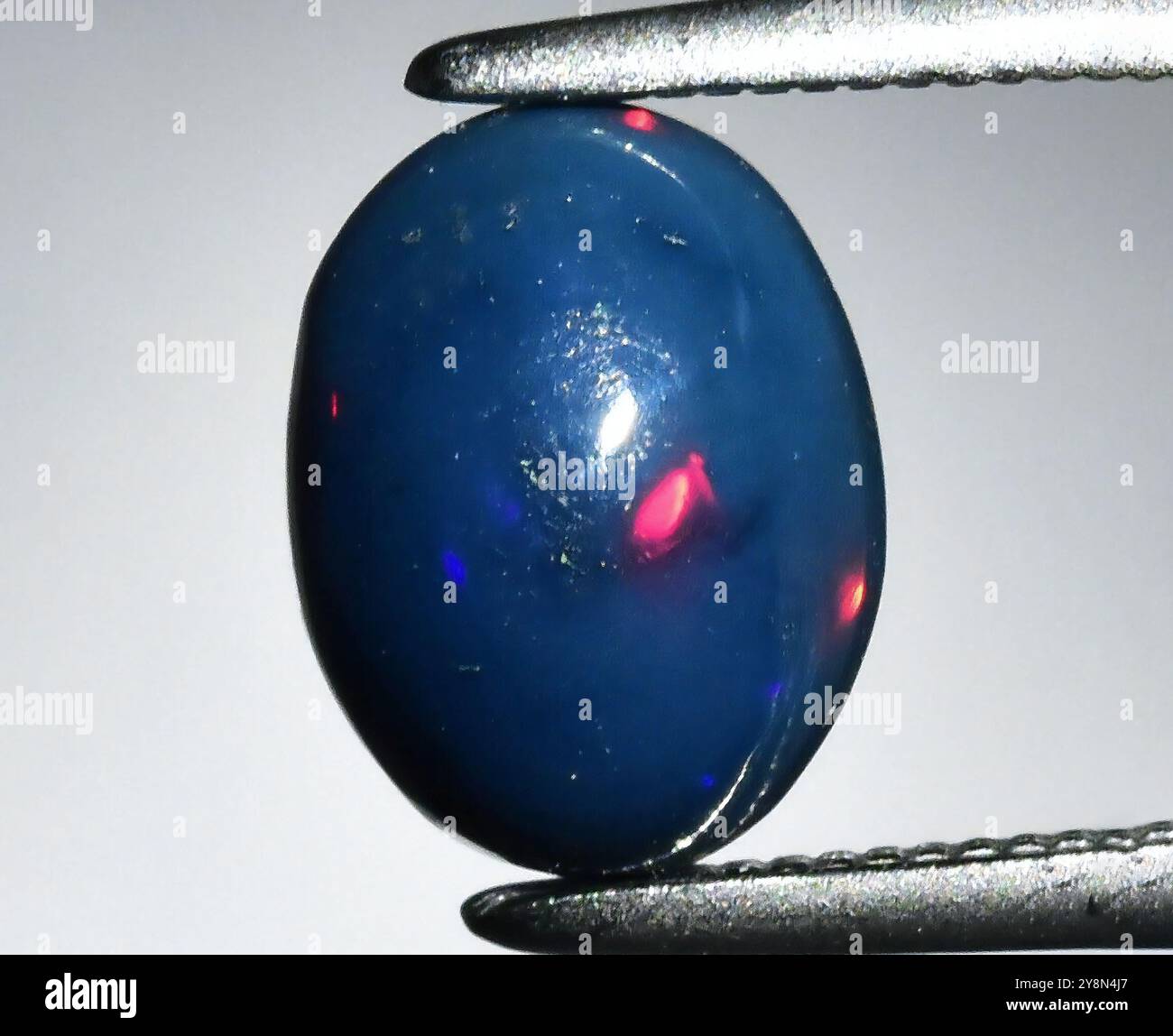 Captivating Blue Opal Gemstone Radiating Vibrant Colors Under Spotlight ...