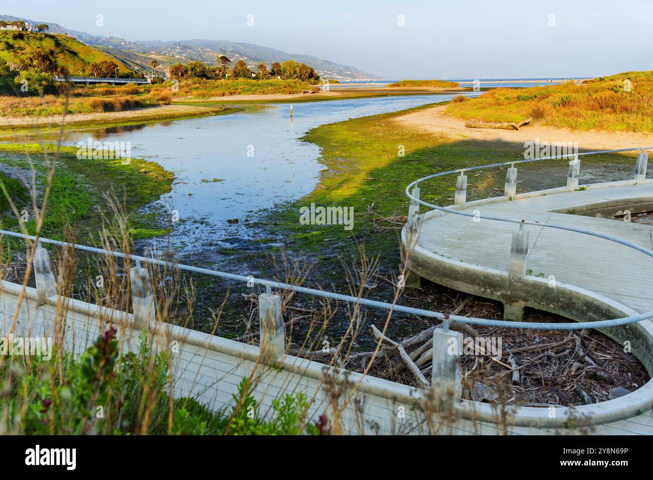 Winding walkway alongside Malibu Lagoon featuring lush greenery and ...