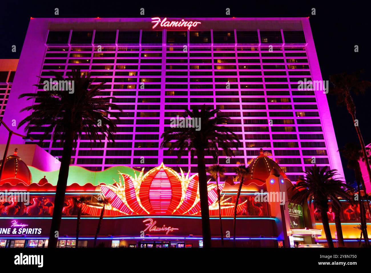 Las Vegas, Nevada - April 13, 2024: Brightly lit Flamingo Hotel facade features vibrant colors ...
