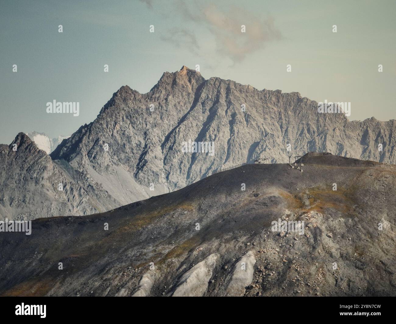 Drone aerial view of the Savognin mountains in Switzerland at sunset, highlighting rugged peaks ...
