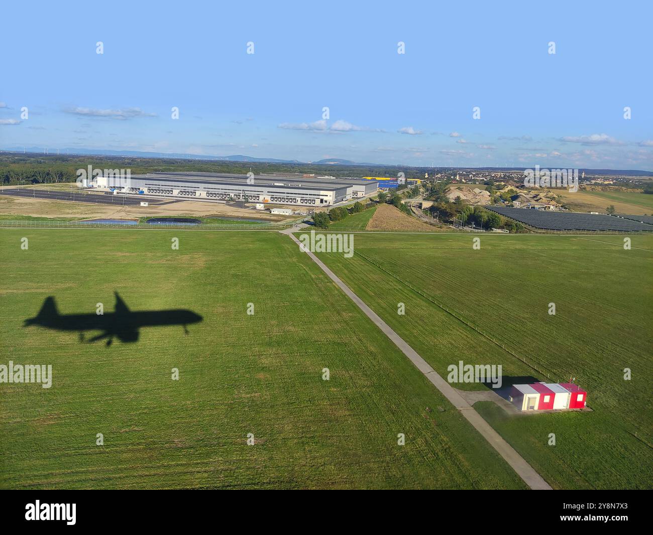 Shadow of a plane during landing on the airport green grass Stock Photo ...
