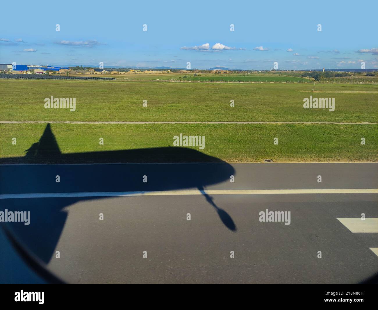 Shadow of a plane during landing on the airport green grass and runway ...