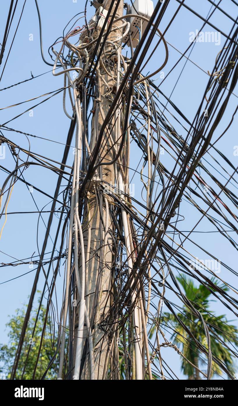 Chaotically connected and stretched wires on an electric pole in Asia ...