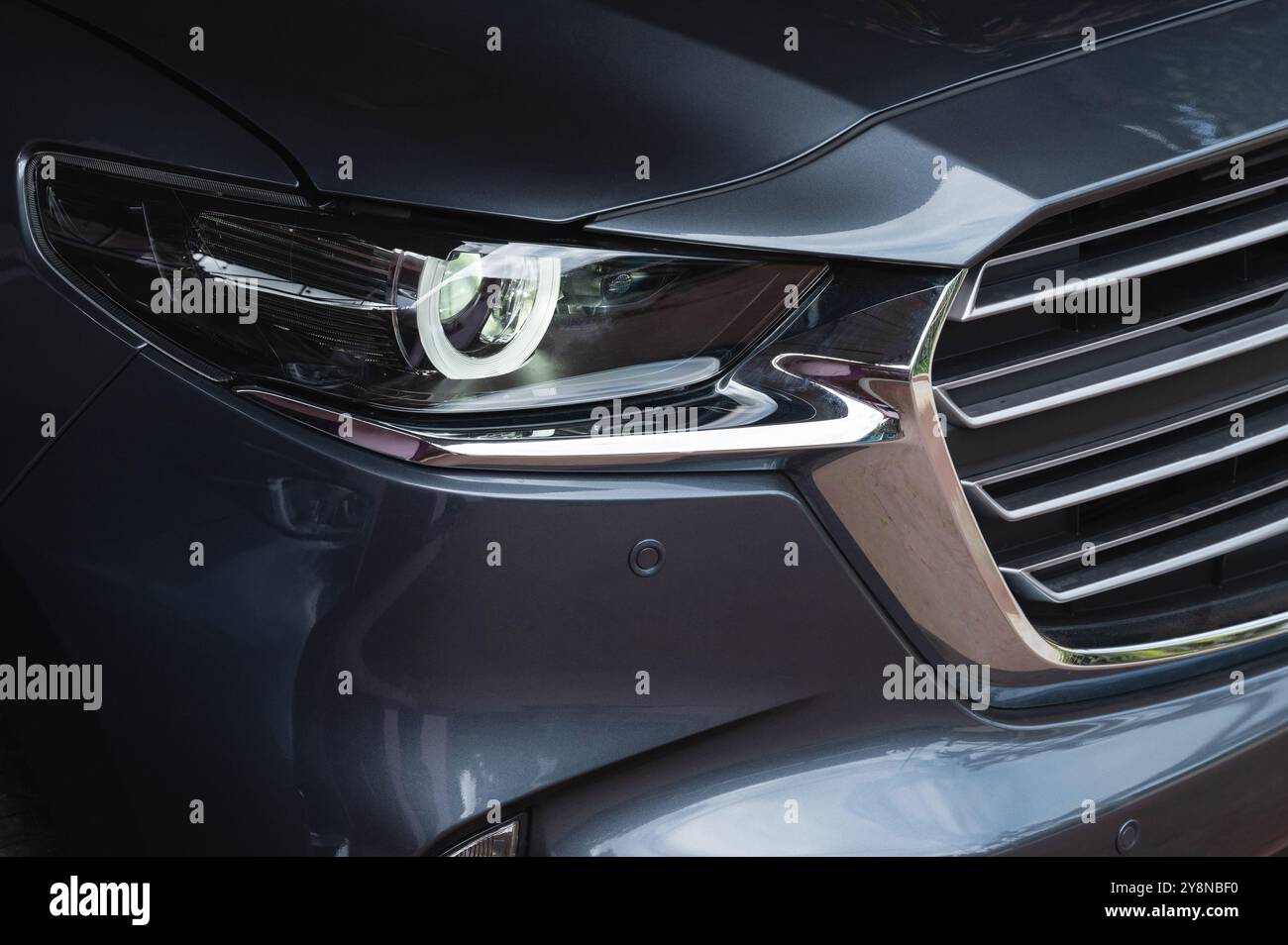 Led moder car headlight on chrome grille front bonnet Stock Photo - Alamy