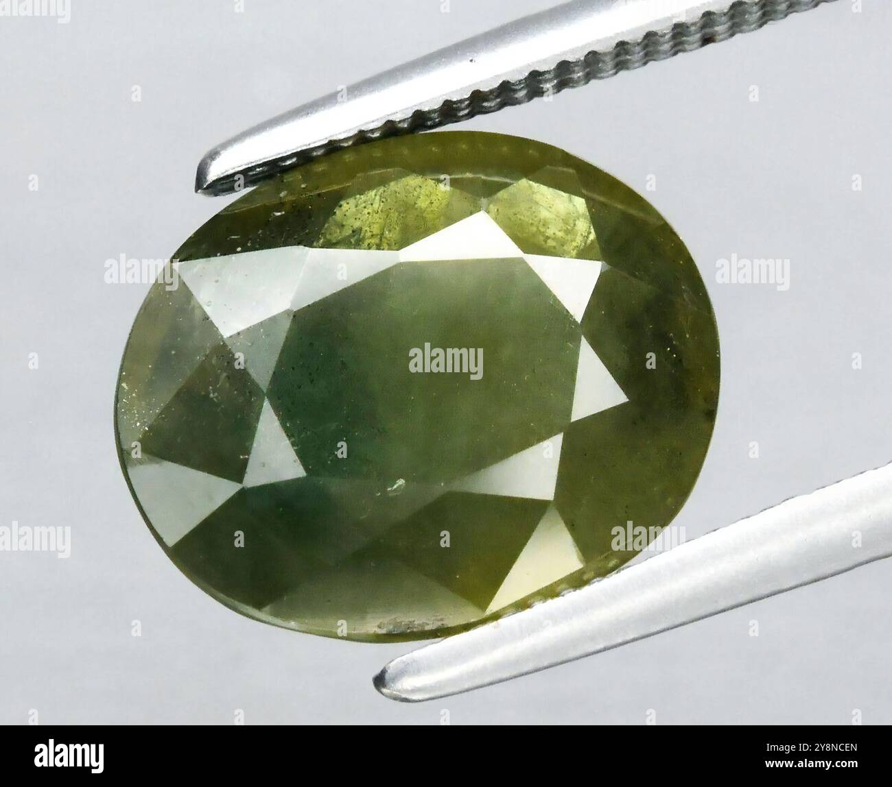 Elegant Olive Green Natural Gemstone with Faceted Cut and Unique ...