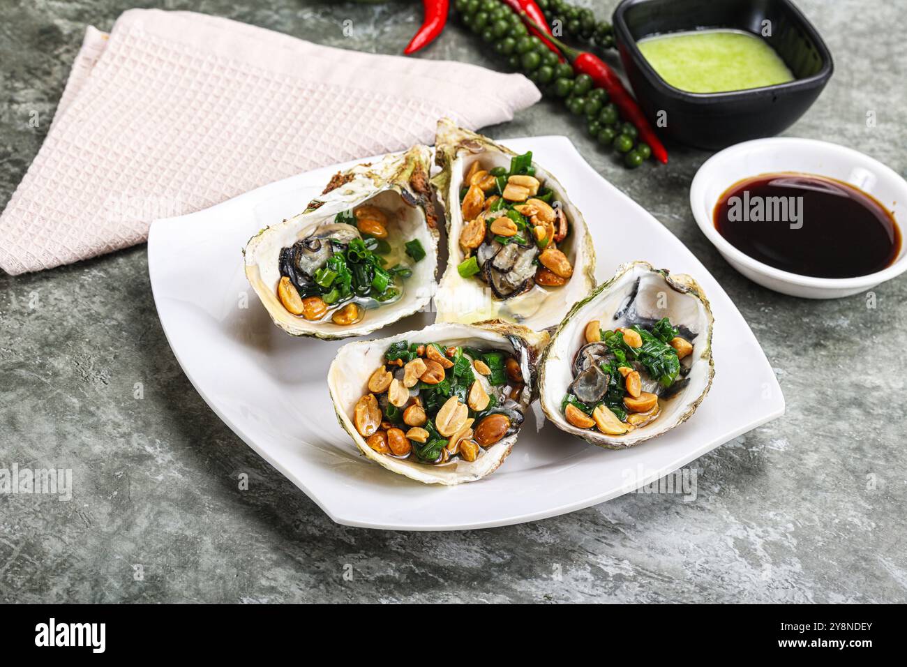 Open half oysters with green onion and peanut Stock Photo - Alamy
