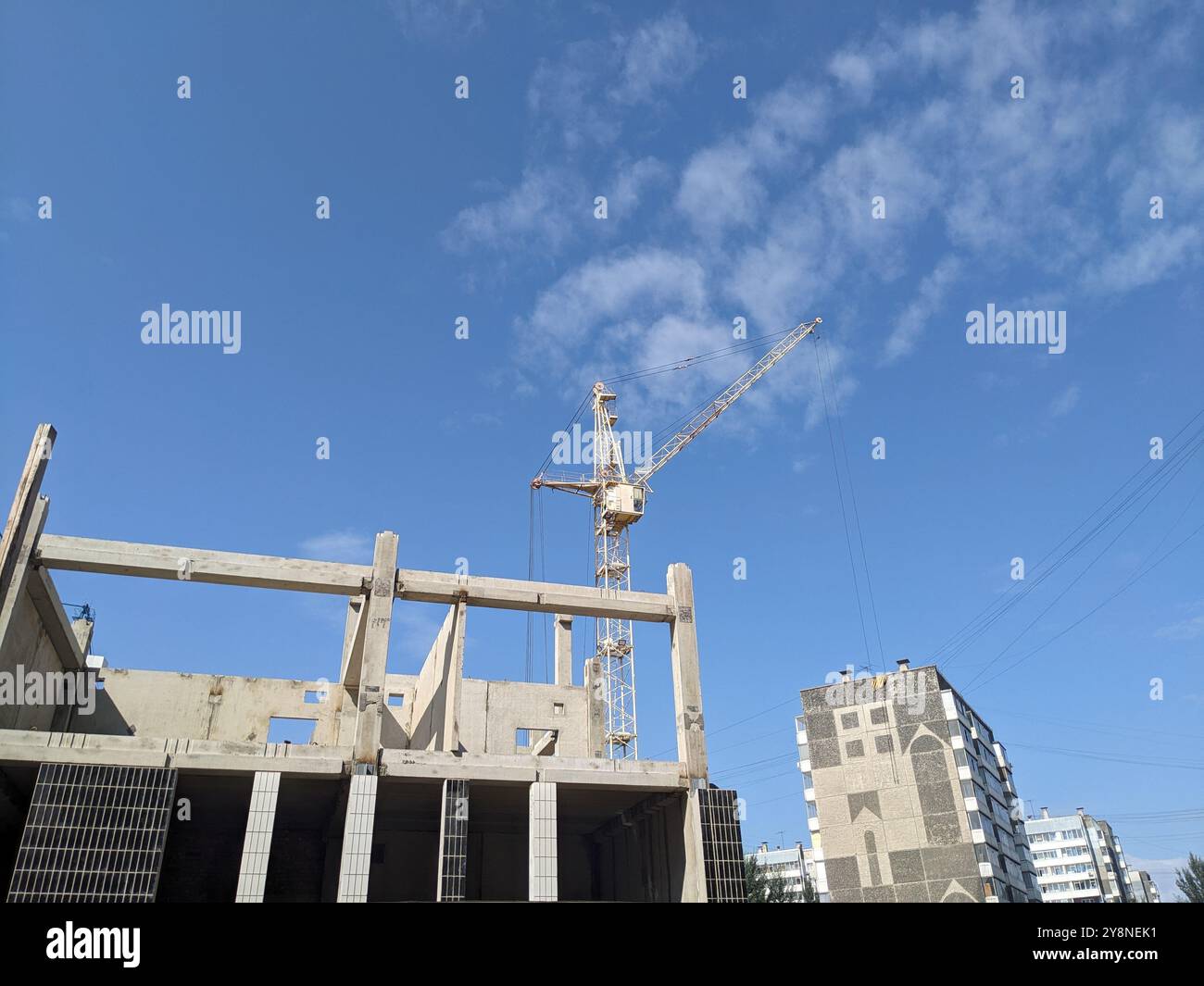 construction of a building with a tower crane Stock Photo - Alamy