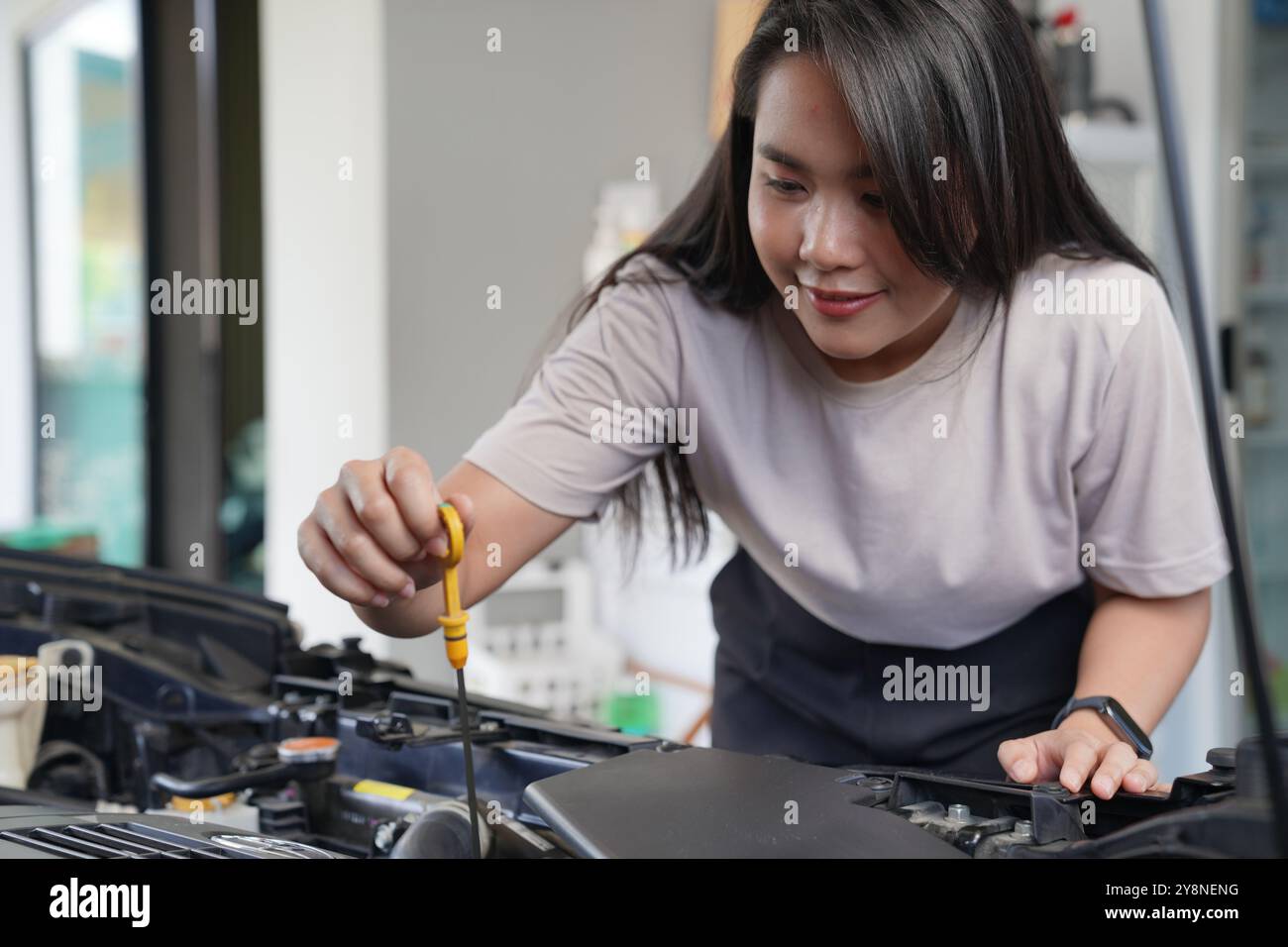 A young female checking a car Stock Photo - Alamy