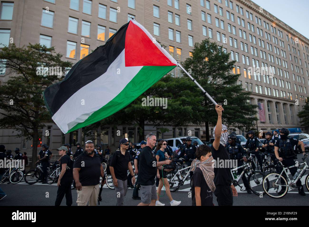 A demonstrator is waving a Palestinian flag during a pro-Palestinian ...