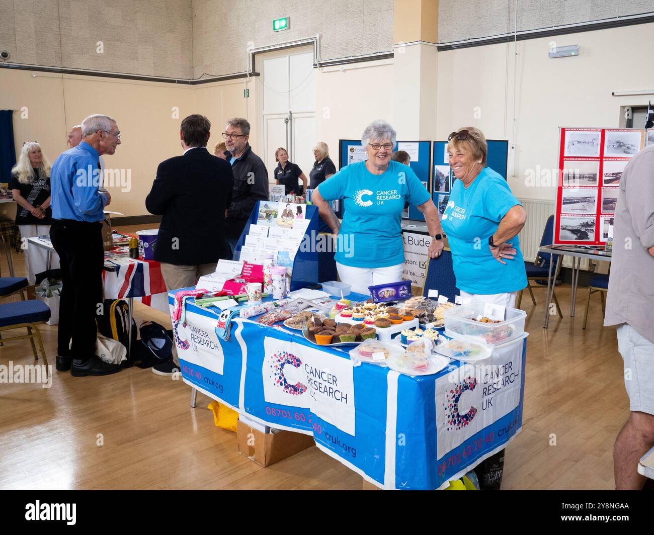 Cancer research charity volunteers selling cakes to raise money Stock ...