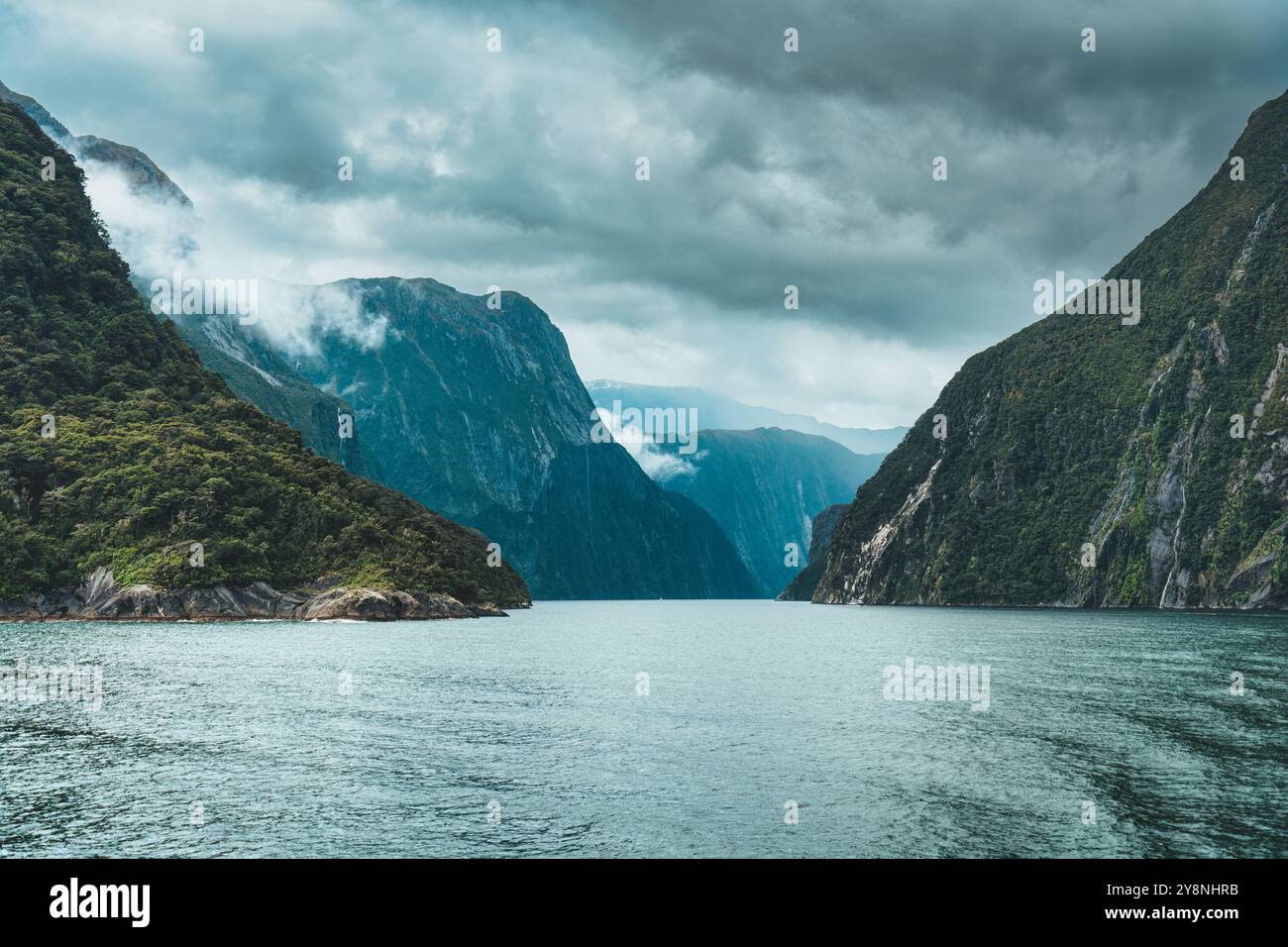 Cruise with majestic mountain and waterfall flowing in Fjord of Milford ...
