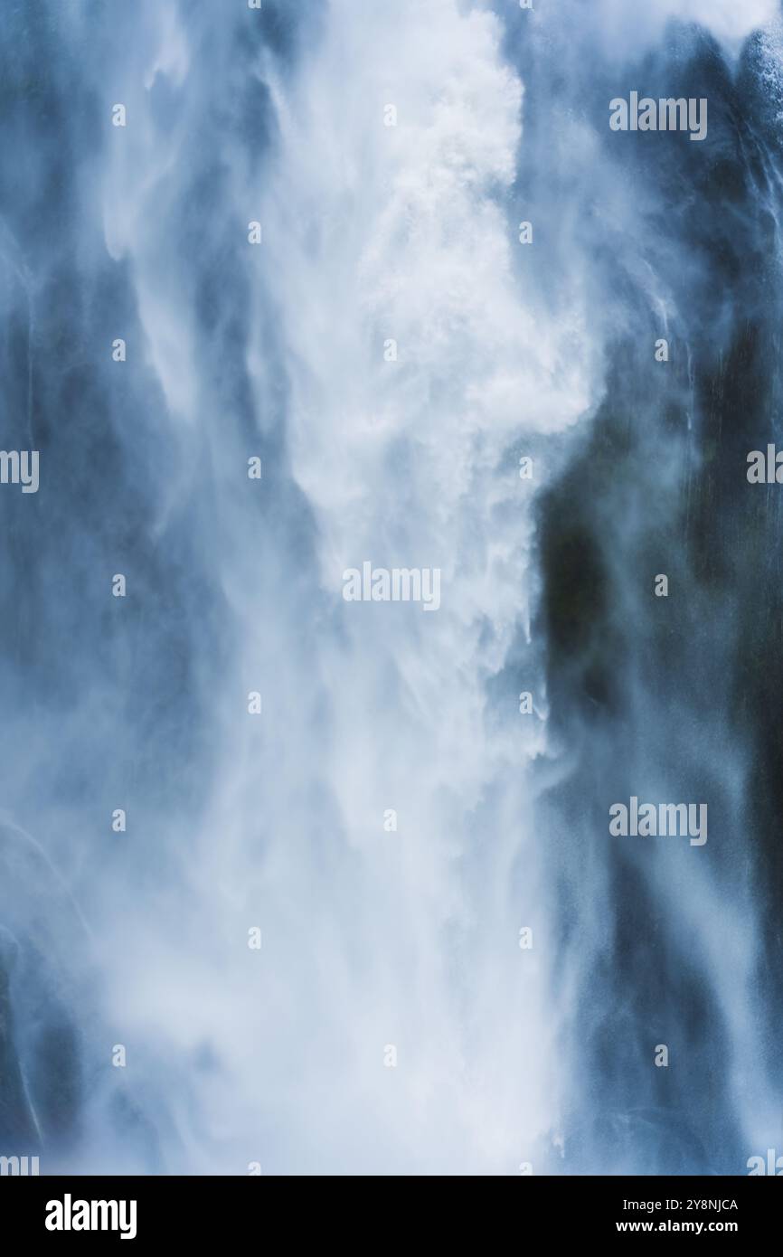 Powerful moody waterfall flowing in tropical rainforest at Milford ...