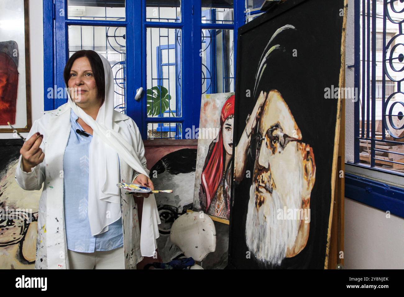 A Palestinian artist paints a portrait of Lebanese Hezbollah leader ...