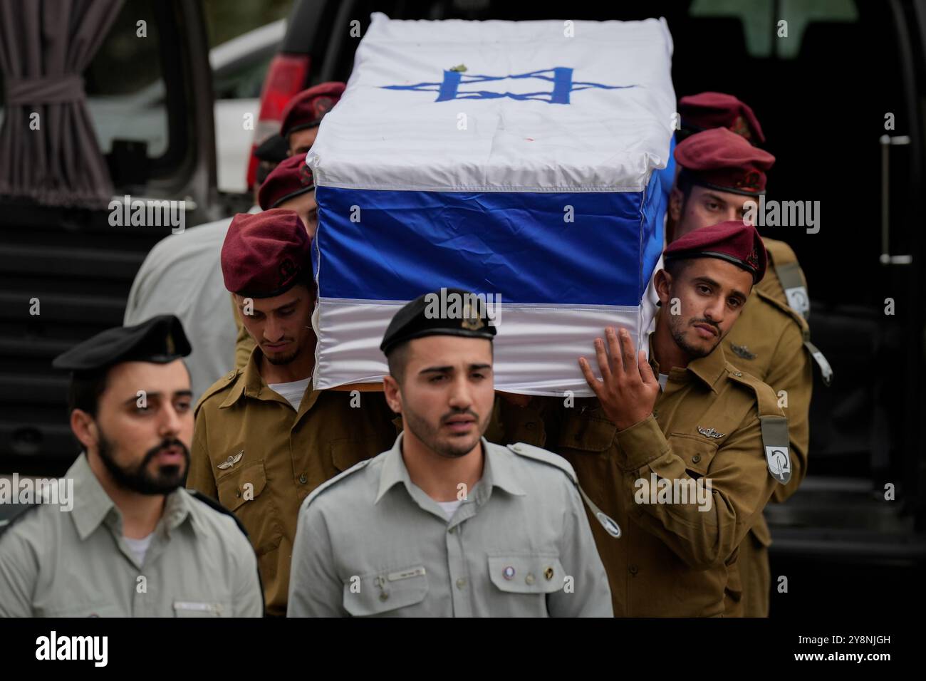 Israeli soldiers carry the flag-draped casket of Sgt. First Class Nazar ...
