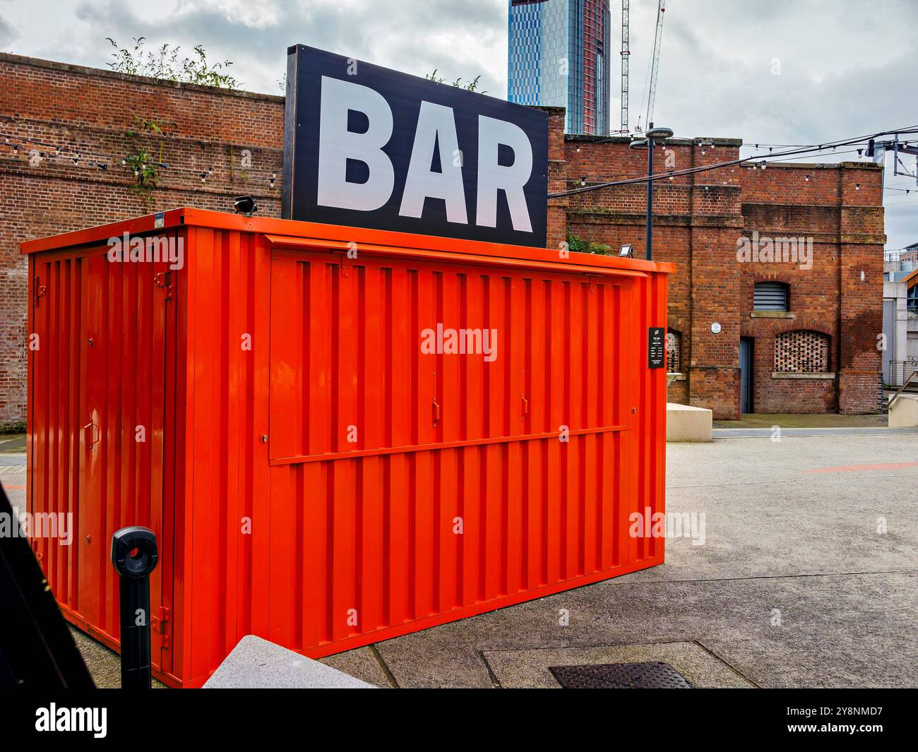 Bright orange shipping container converted into an outdoor bar setting ...