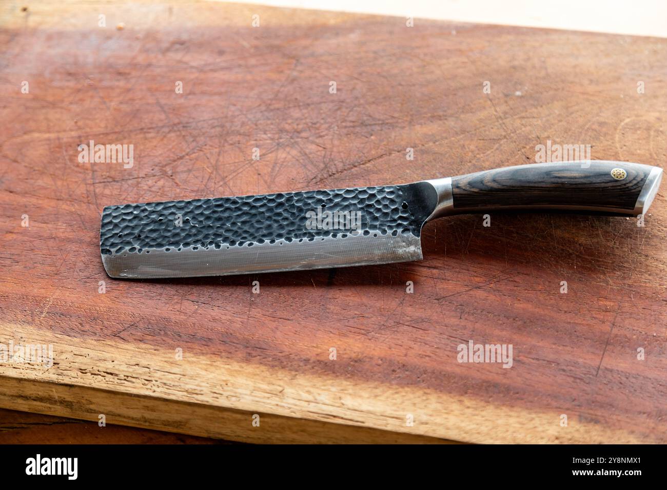 Rustic handcrafted cleaver with wooden handle and textured finish Stock ...