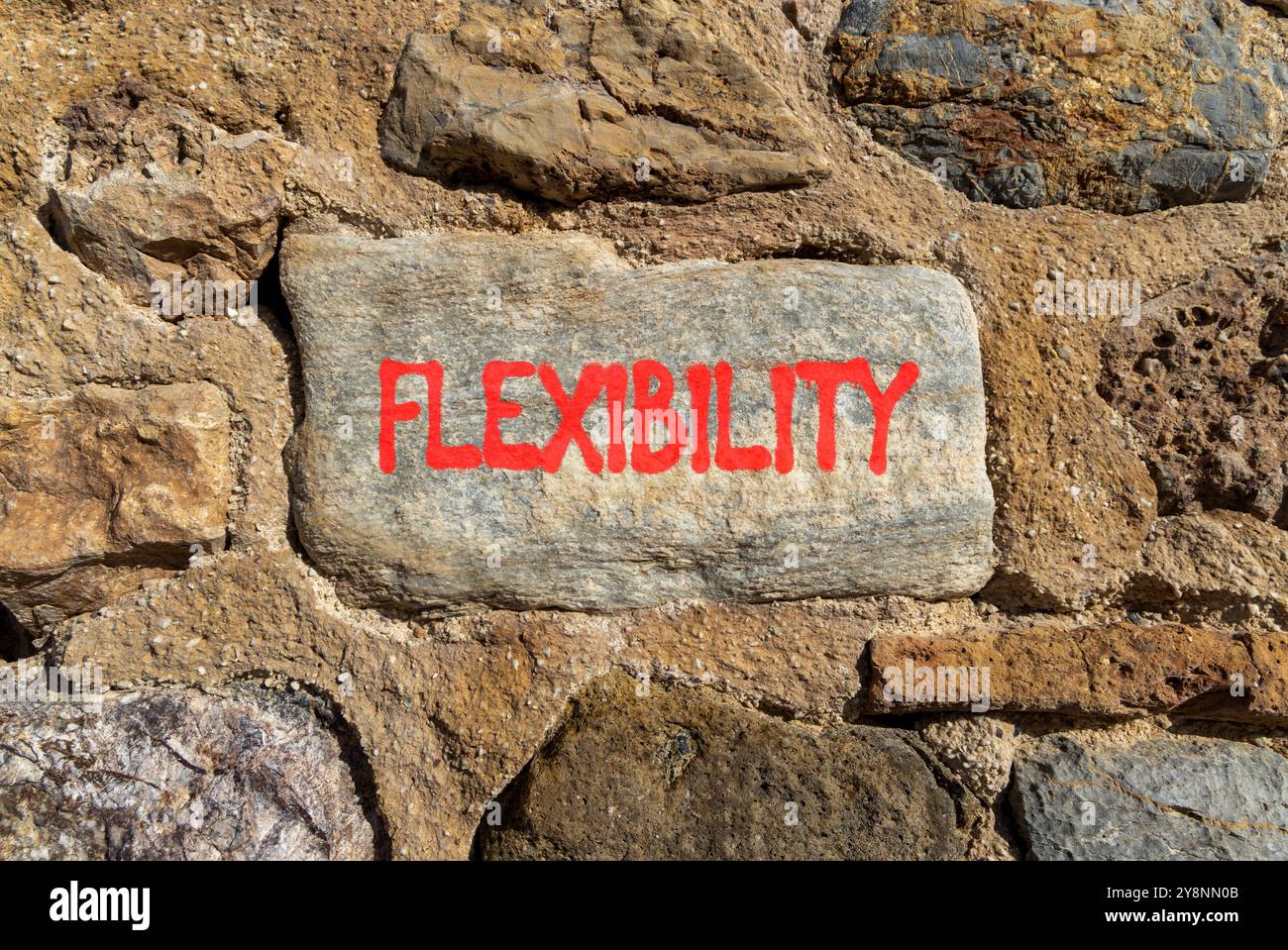 Flexibility symbol. Concept word Flexibility on beautiful grey volcanic ...