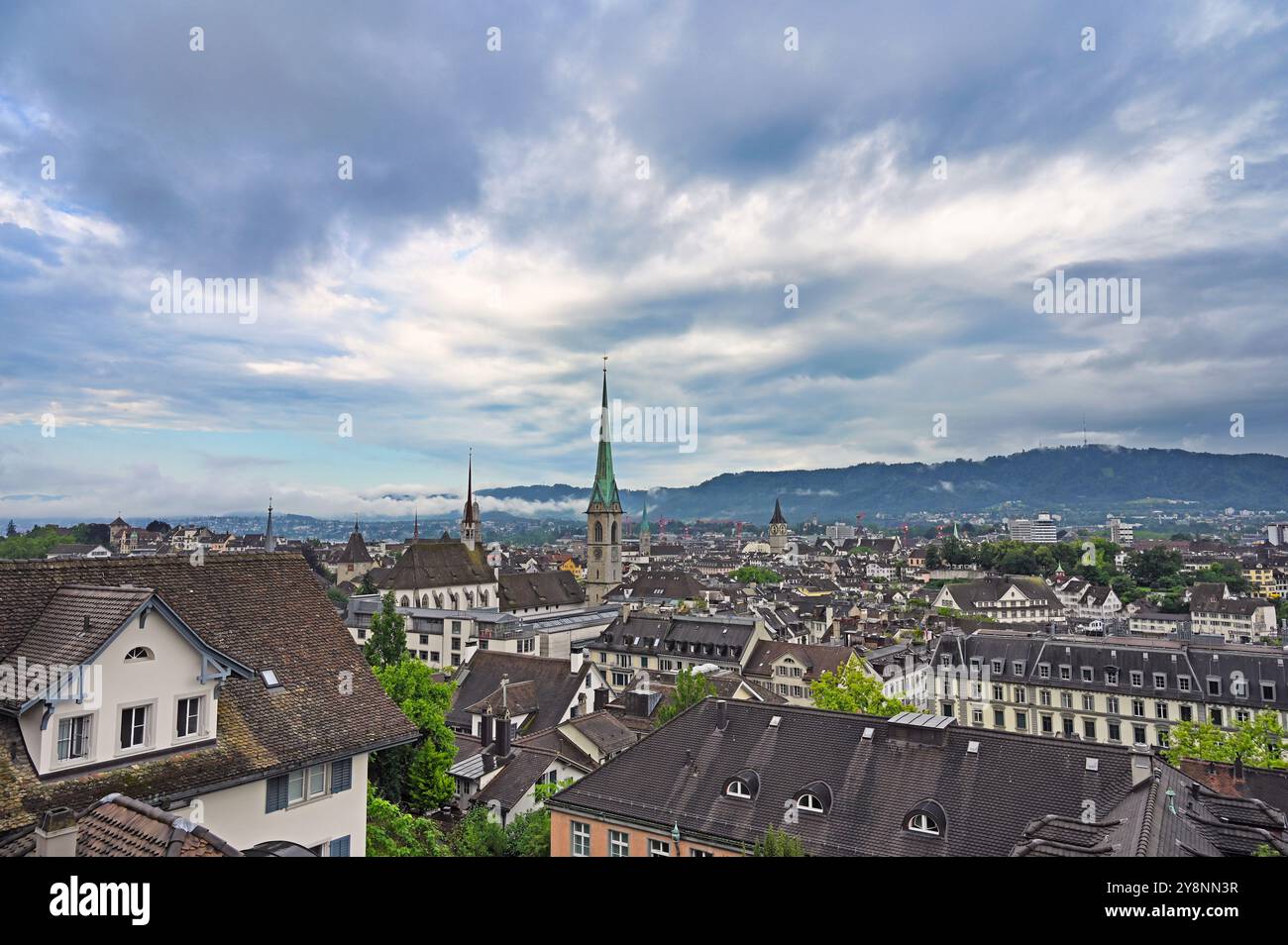 Church clock towers and buildings in old town Zurich skyline, cloudy ...