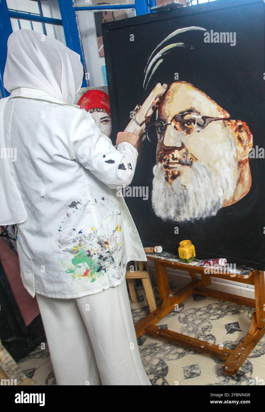 Nablus, Palestine. 05th Oct, 2024. A Palestinian artist paints a ...