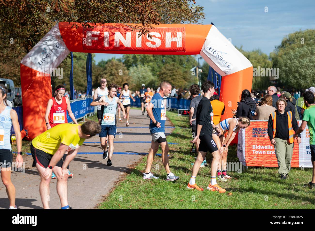 Runners cross the finishing line. The Bidwells Cambridge 10k is part of ...