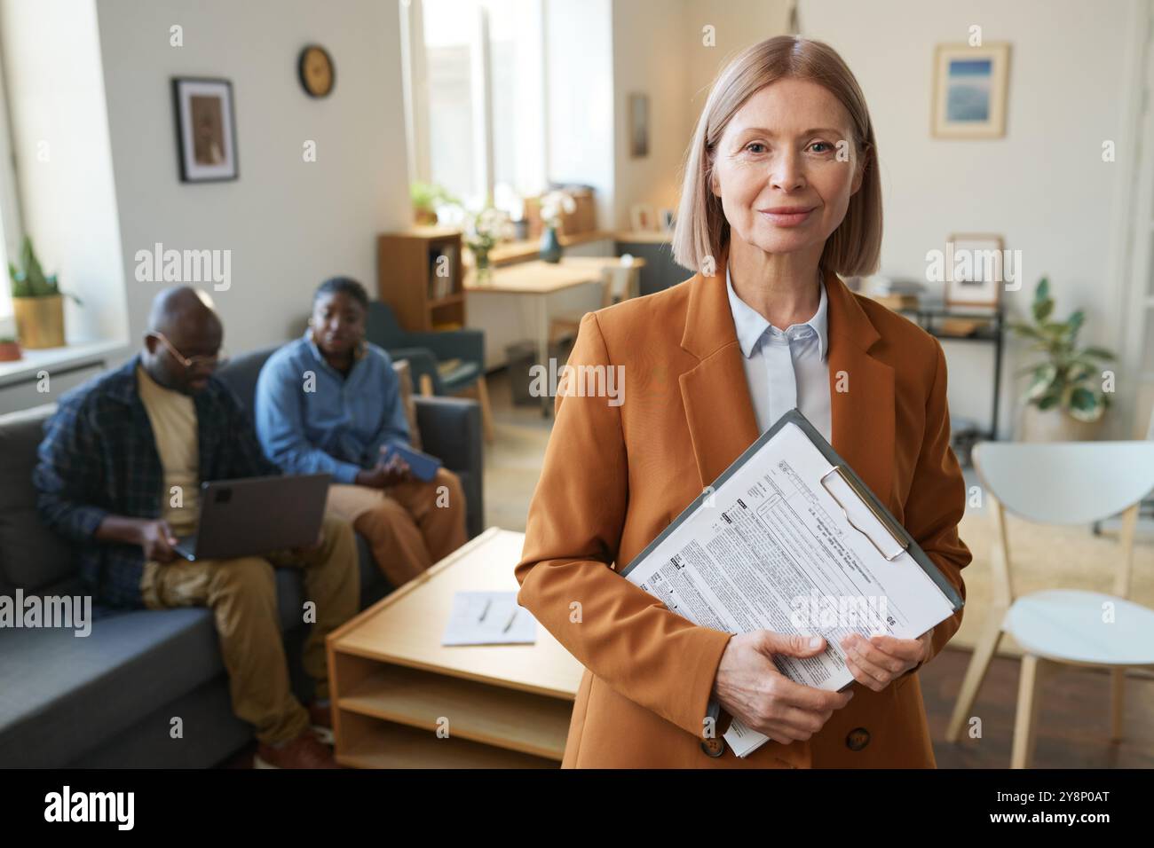 Smiling Mature Woman As Finance Expert Stock Photo - Alamy