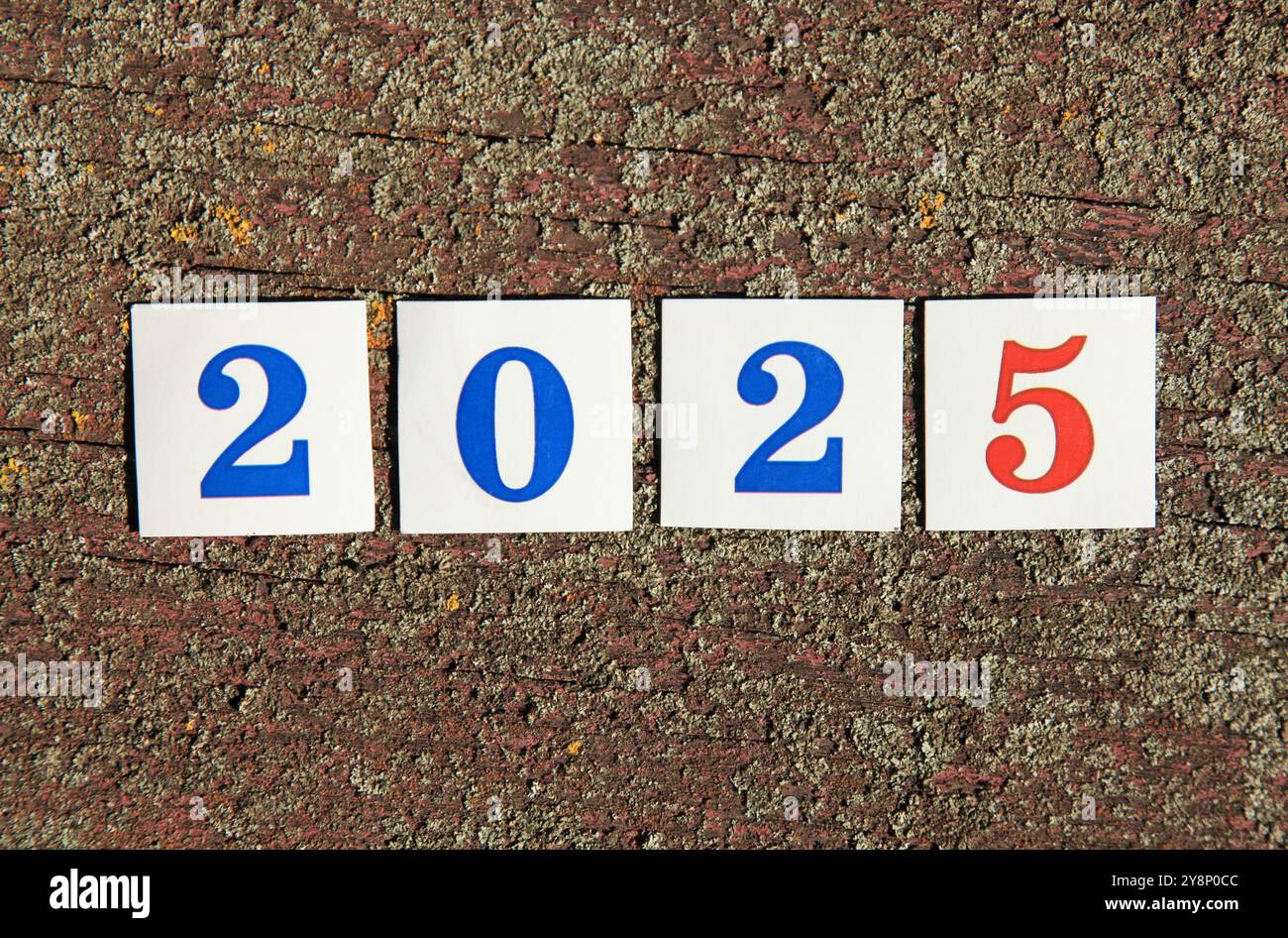 Numbers of 2025 year. Paper square numbers on the wooden background ...