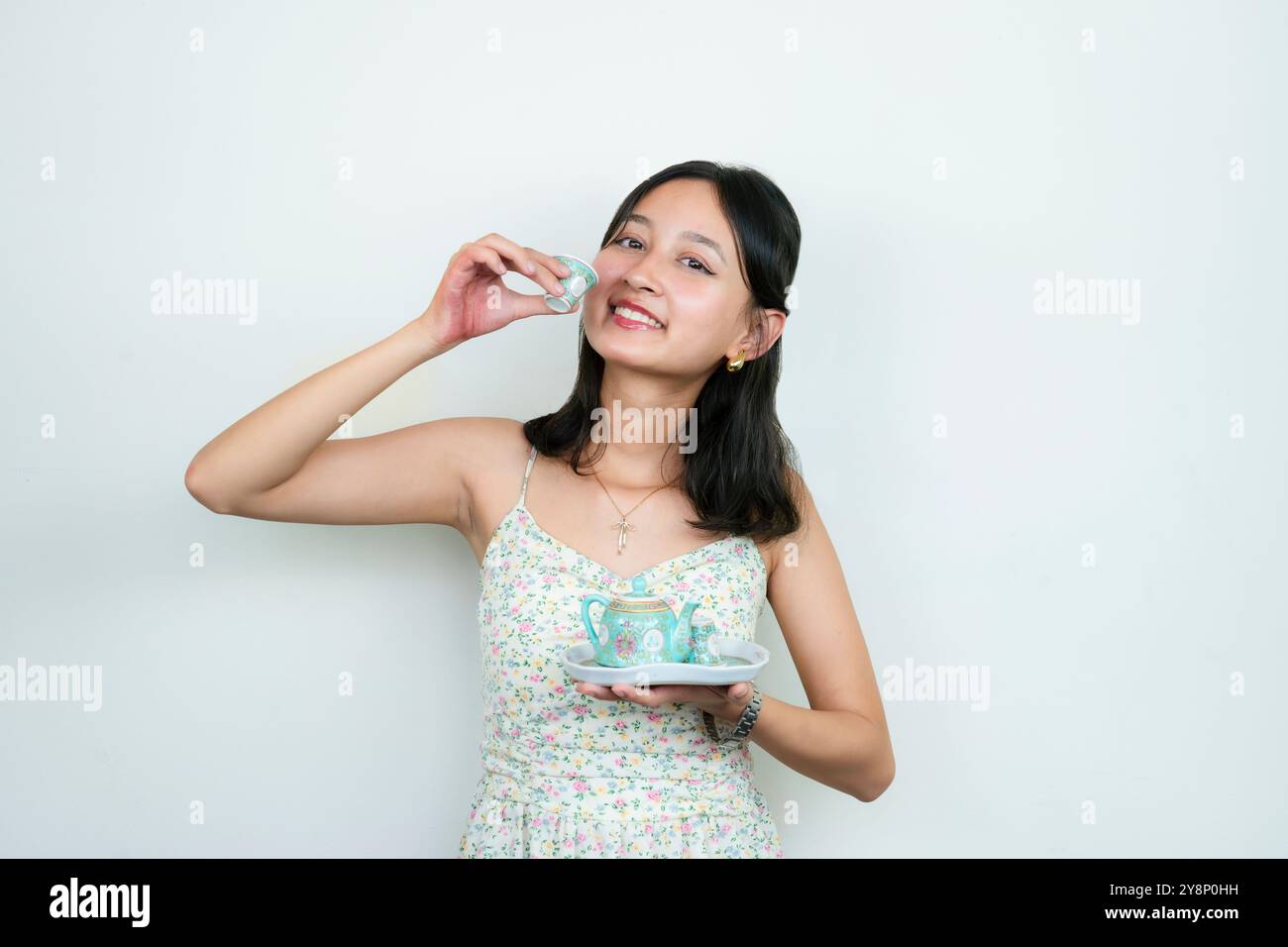 Young Asian girl drinking green tea from a Chinese teapot Stock Photo ...