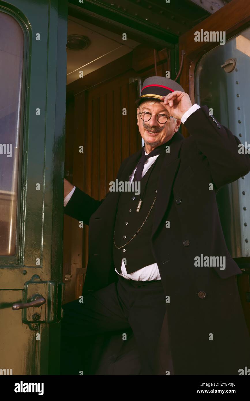 Reenactment scene with authentic 1927 1st class train carriage and a ...