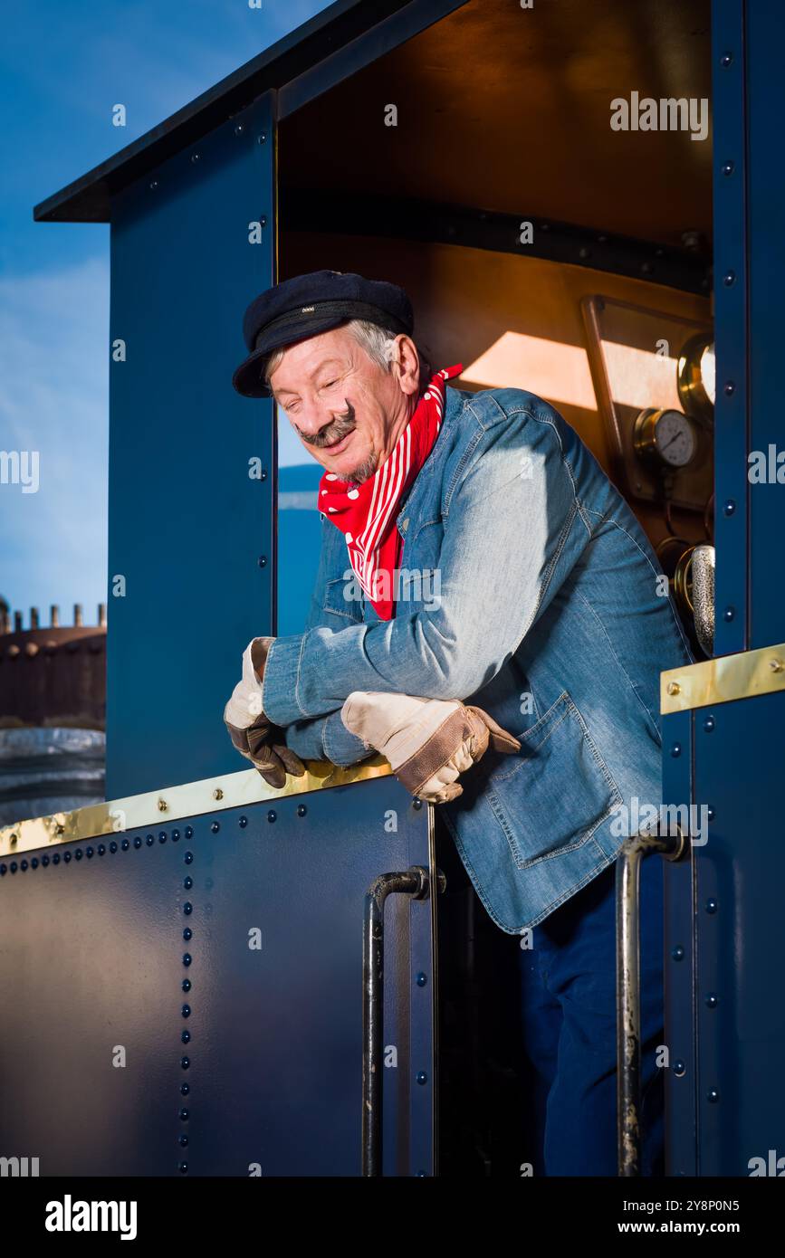 Reenactment scenes of a vintage worker or machinist in an authentic ...