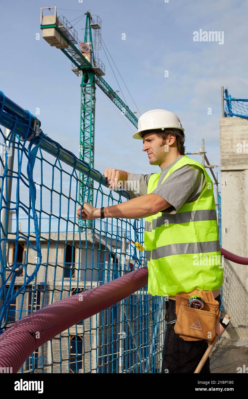 Mason, Bricklayer with personal protective equipment, PPE, Apartment ...