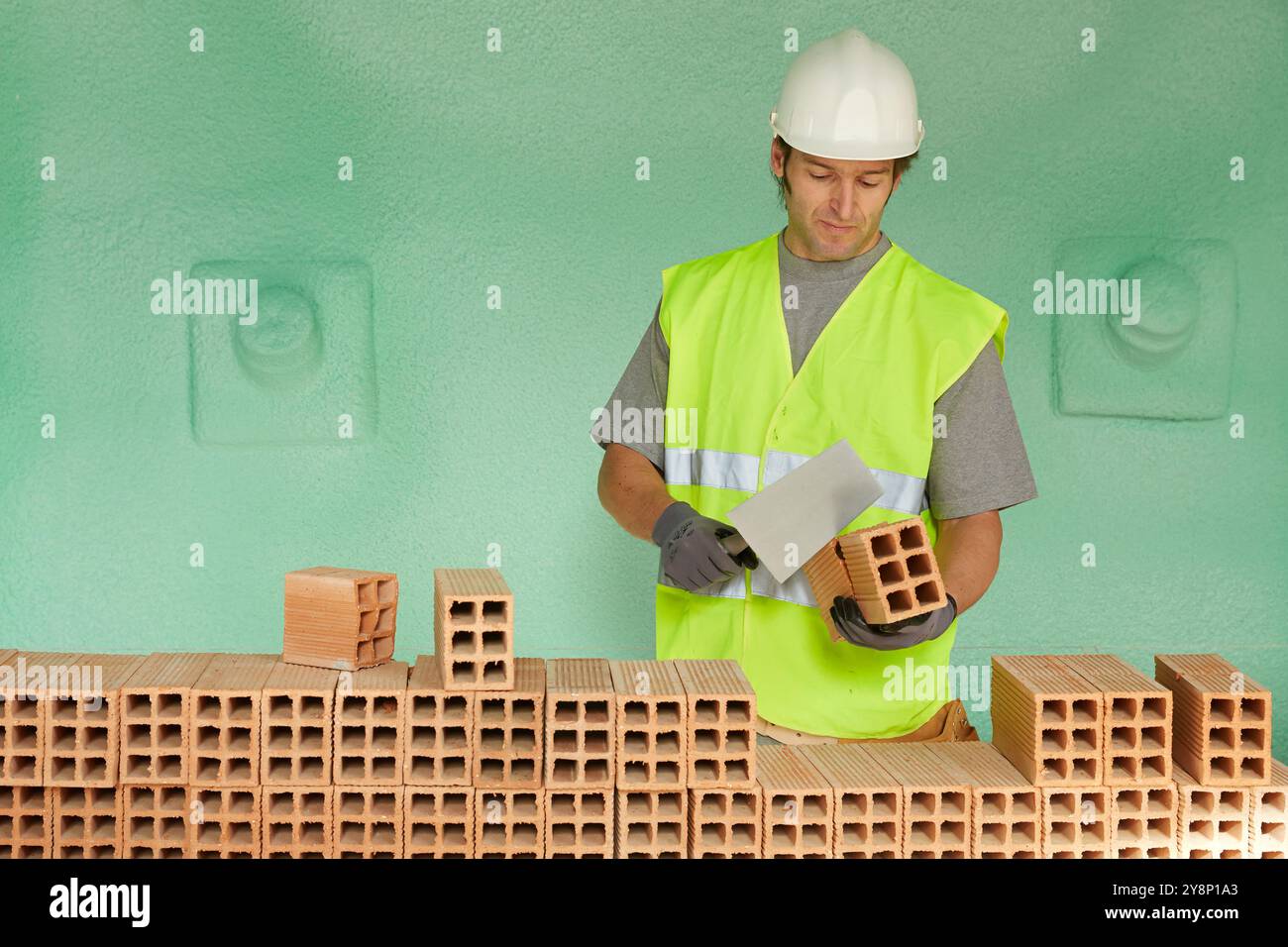 Bricklayer with trowel making a brick wall, Mason with personal ...