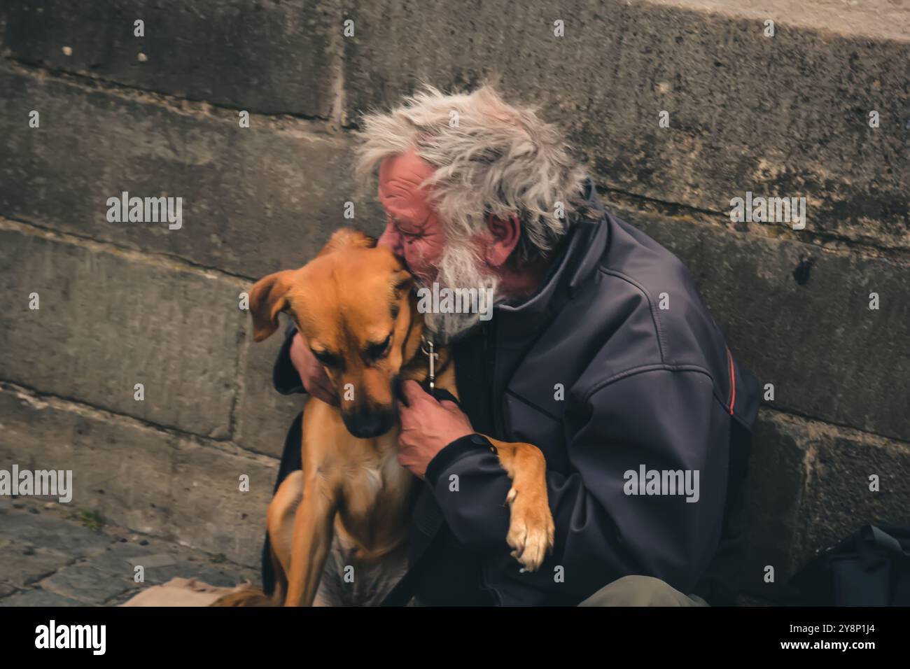 Sad beggar sitting head down hi-res stock photography and images - Alamy
