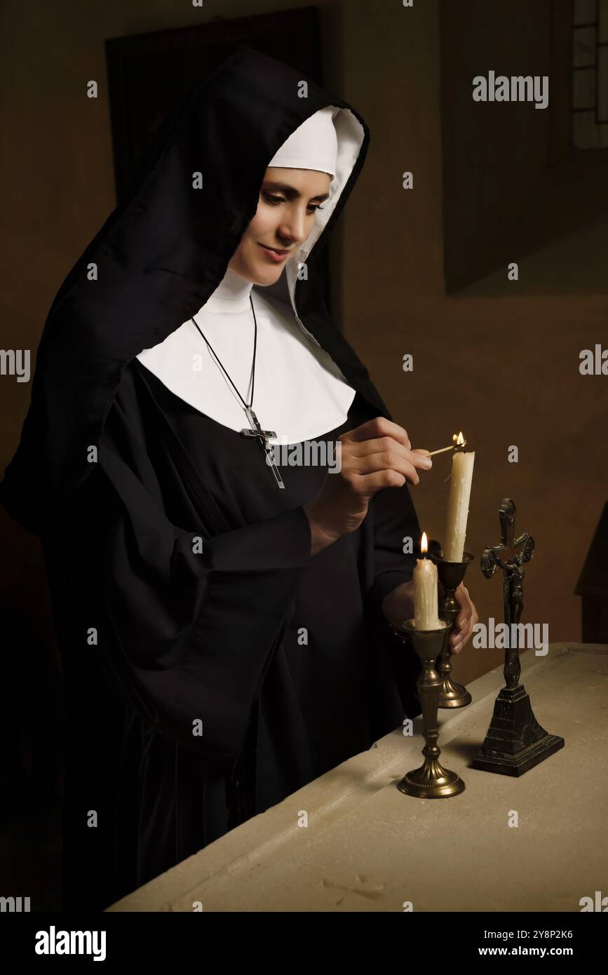 Young adult woman dressed in authentic habit and veil of a catholic nun ...