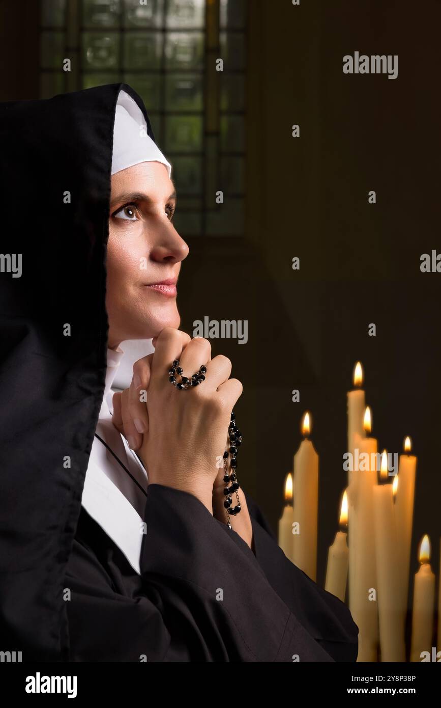 Young adult woman dressed in authentic habit and veil of a catholic nun ...