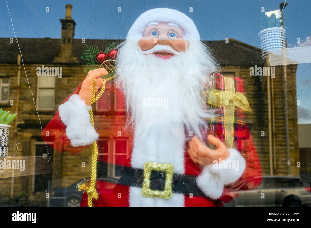 A model of Santa Claus in a shop window display Stock Photo - Alamy