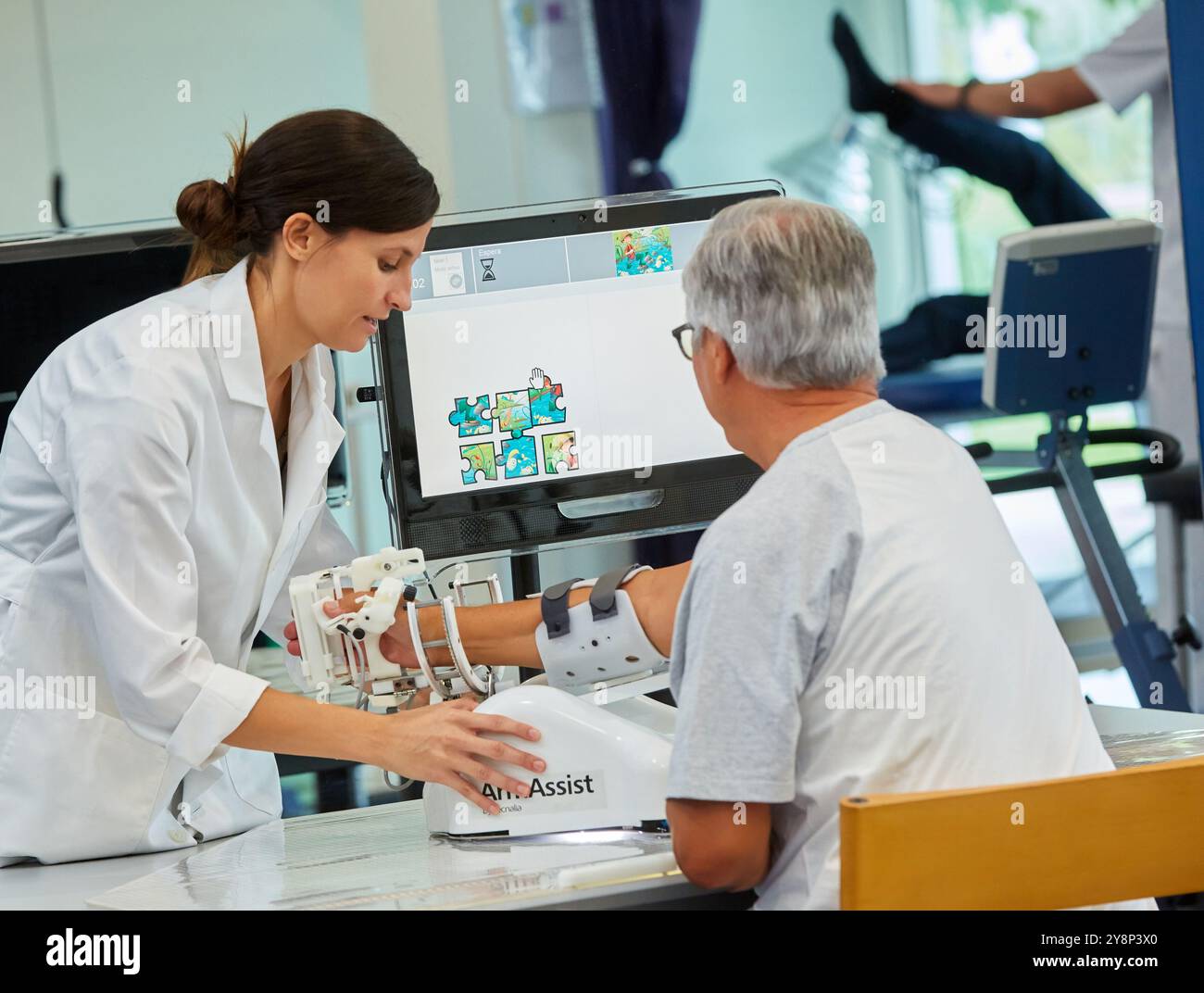 Therapist and patient with assistive robot for upper limb ...