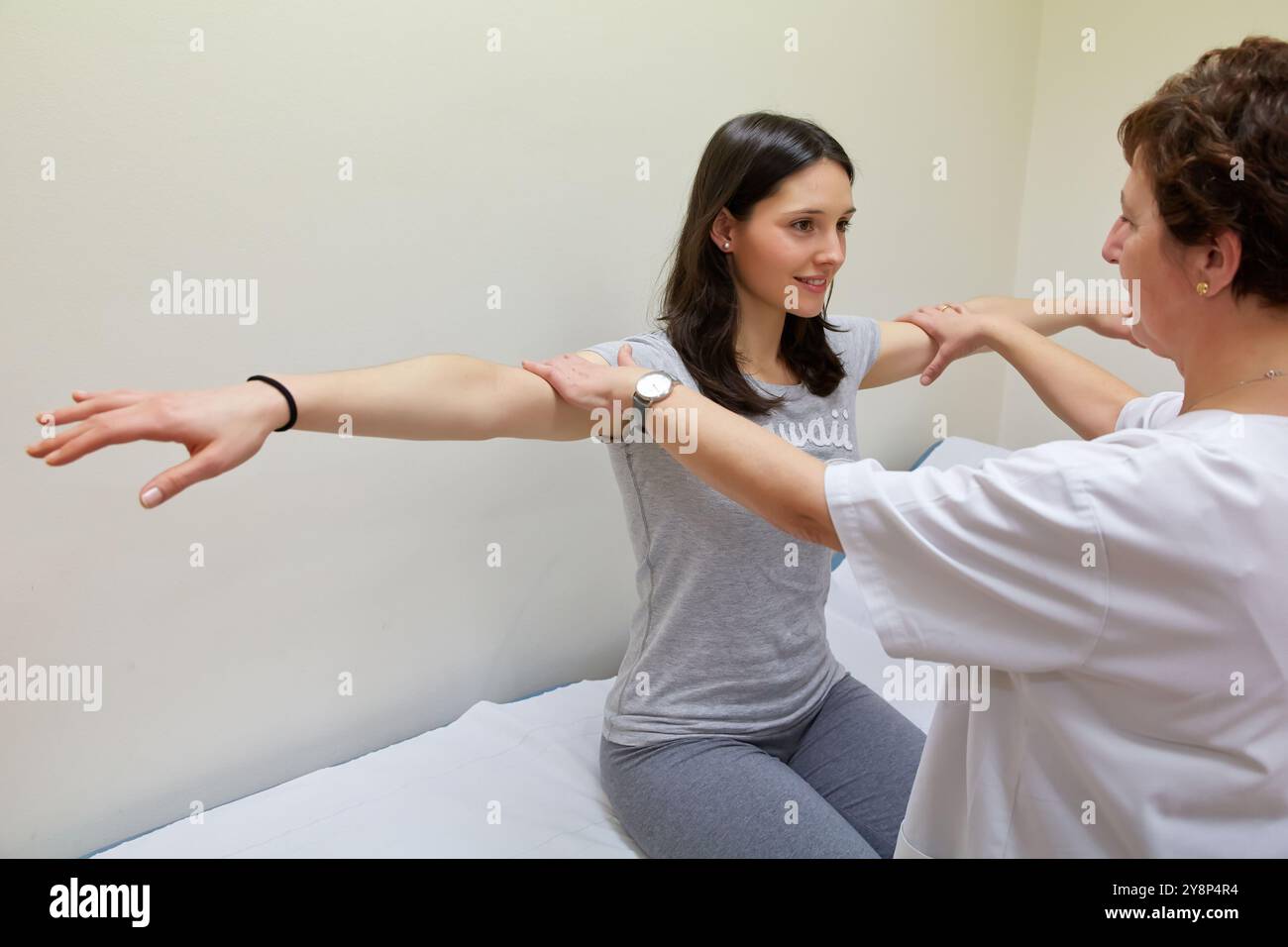 Doctor checking arm abduction strength, Physiotherapy medical center ...