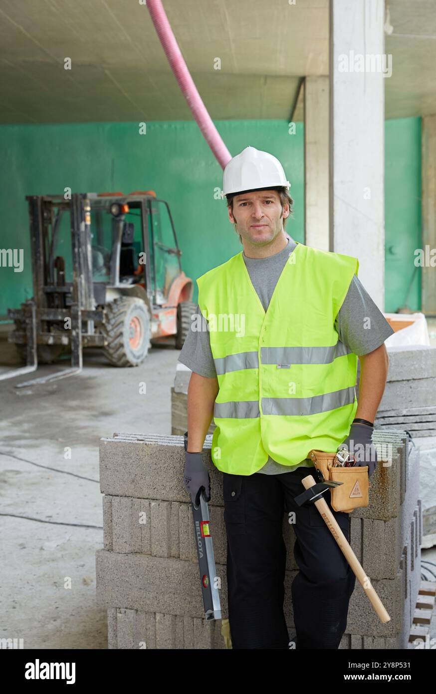 Bricklayer, Mason with personal protective equipment, PPE, Apartment ...